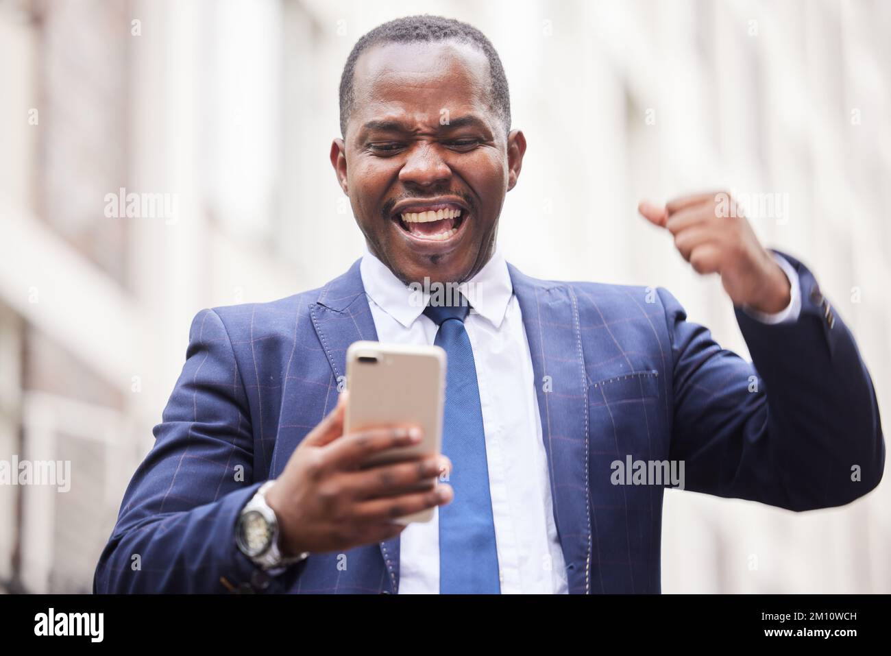 Excited successful african man reading hi-res stock photography and ...