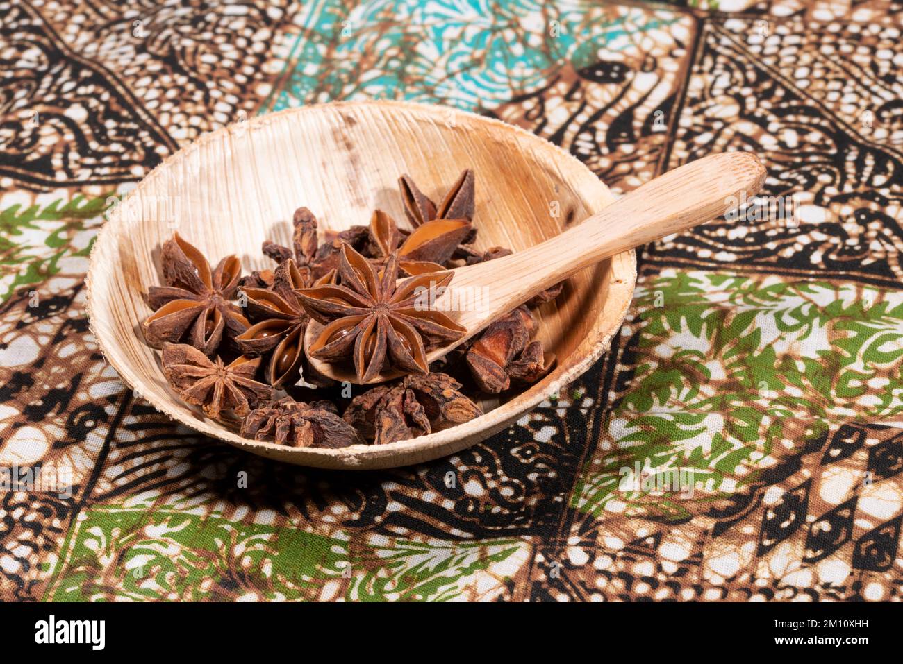 Asterisk on wooden spoon on a batik table cloth Stock Photo - Alamy