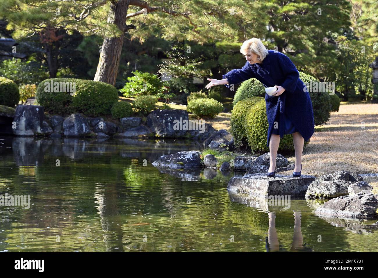 Princess Astrid of Belgium throws food in the water of a pond, after ...