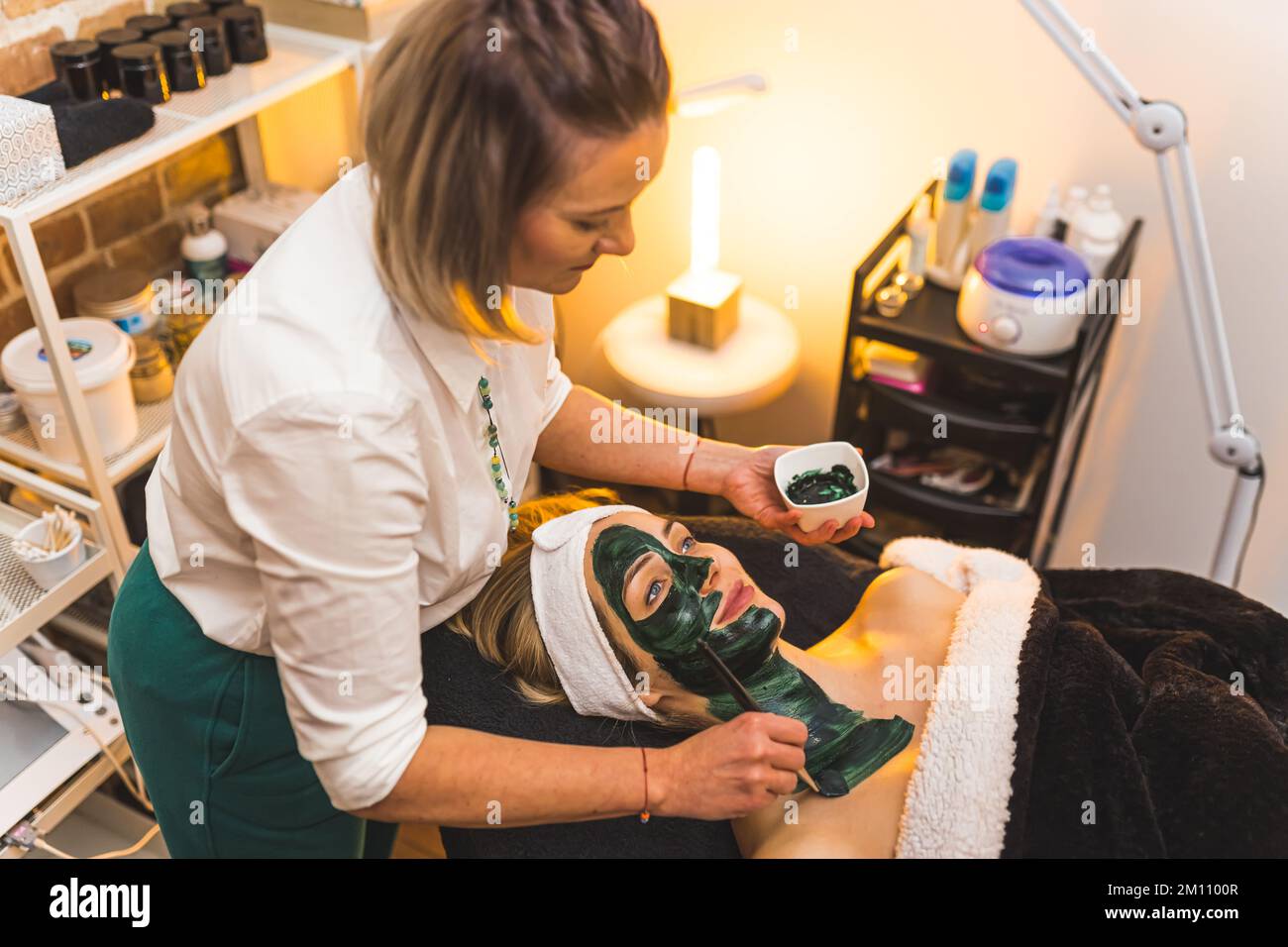 beautiful Caucasian Blonde woman enjoying getting professional facial ...