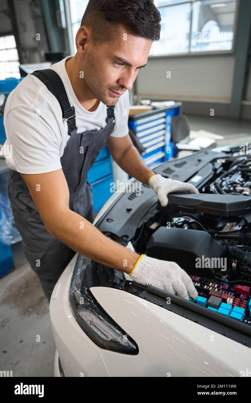 Close up photo of mechanic checking parts of automobile Stock Photo - Alamy