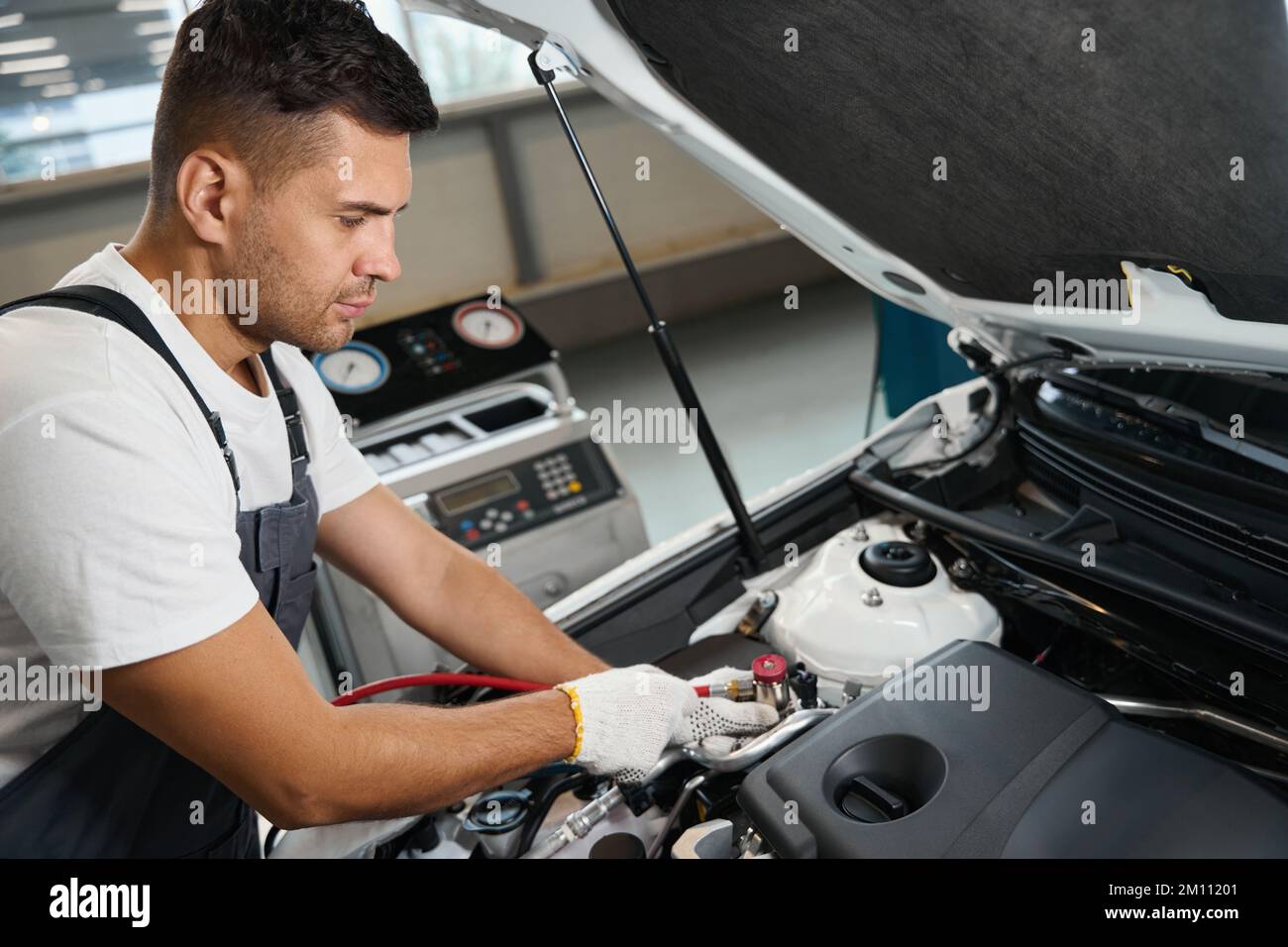 Male checking technical condition of auto parts Stock Photo - Alamy