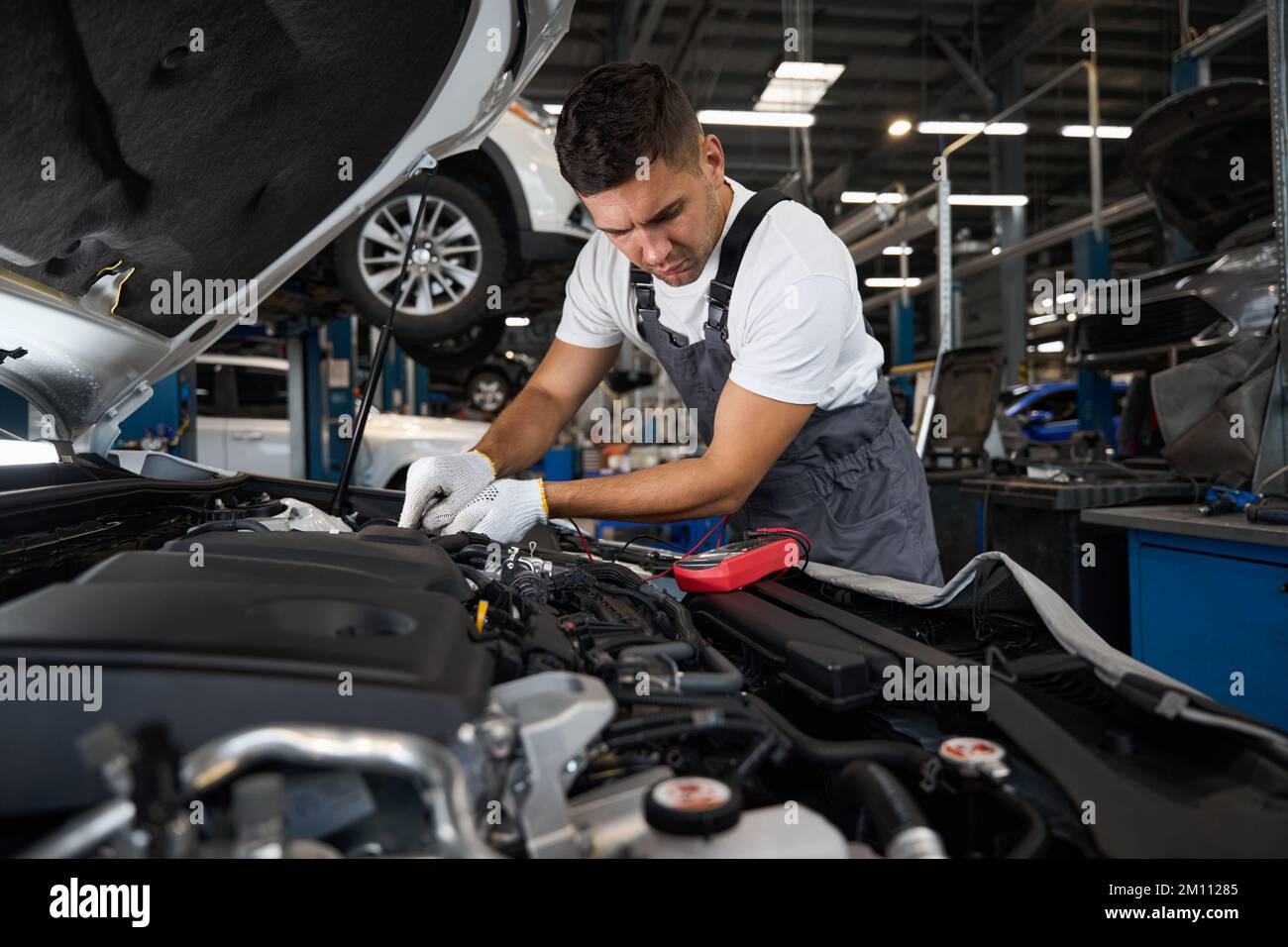 Mechanic checking car battery repairman hi-res stock photography and ...