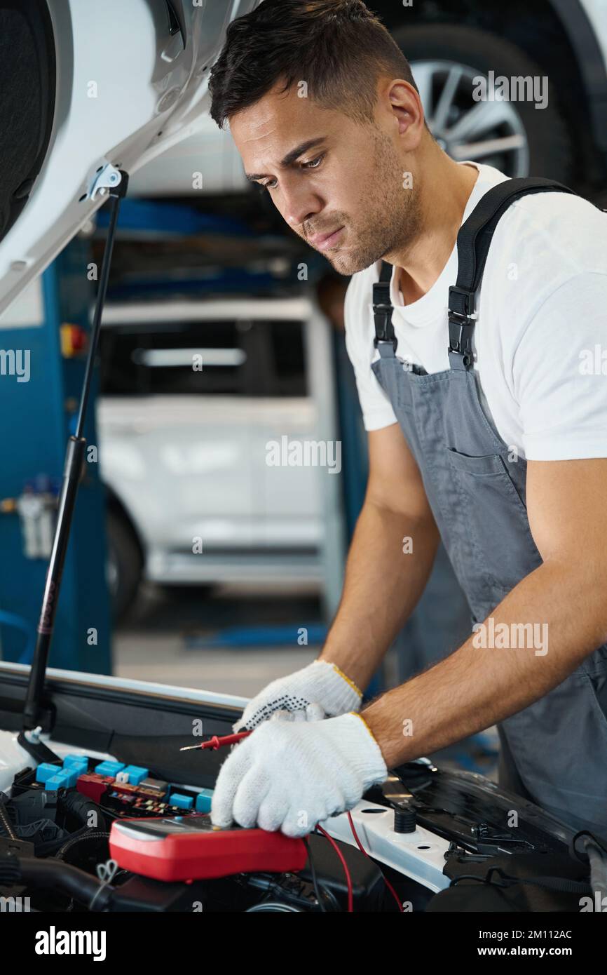 Mechanic checking car battery repairman hi-res stock photography and ...