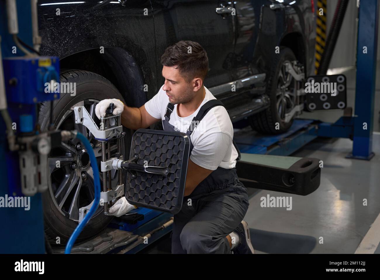 Male put device for technical testing on car wheel Stock Photo - Alamy