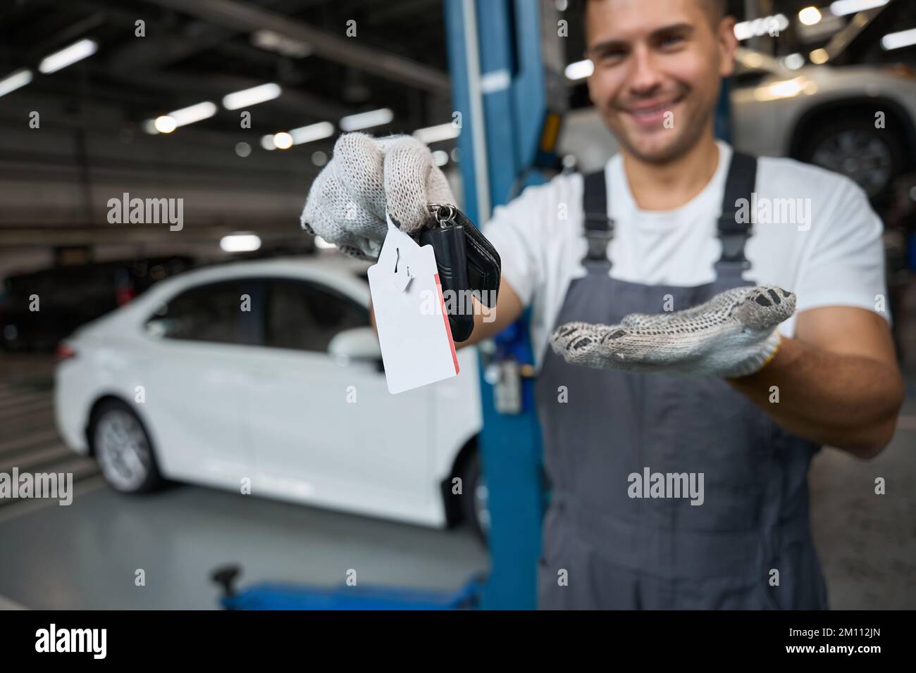 Mechanic giving car key man hi-res stock photography and images - Alamy