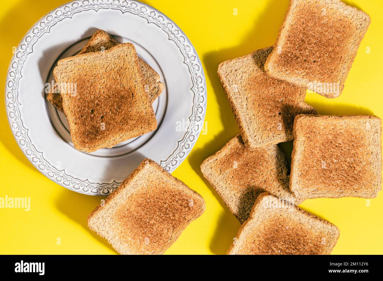 Gray plate with slice of toasted bread and several slices of toasted ...