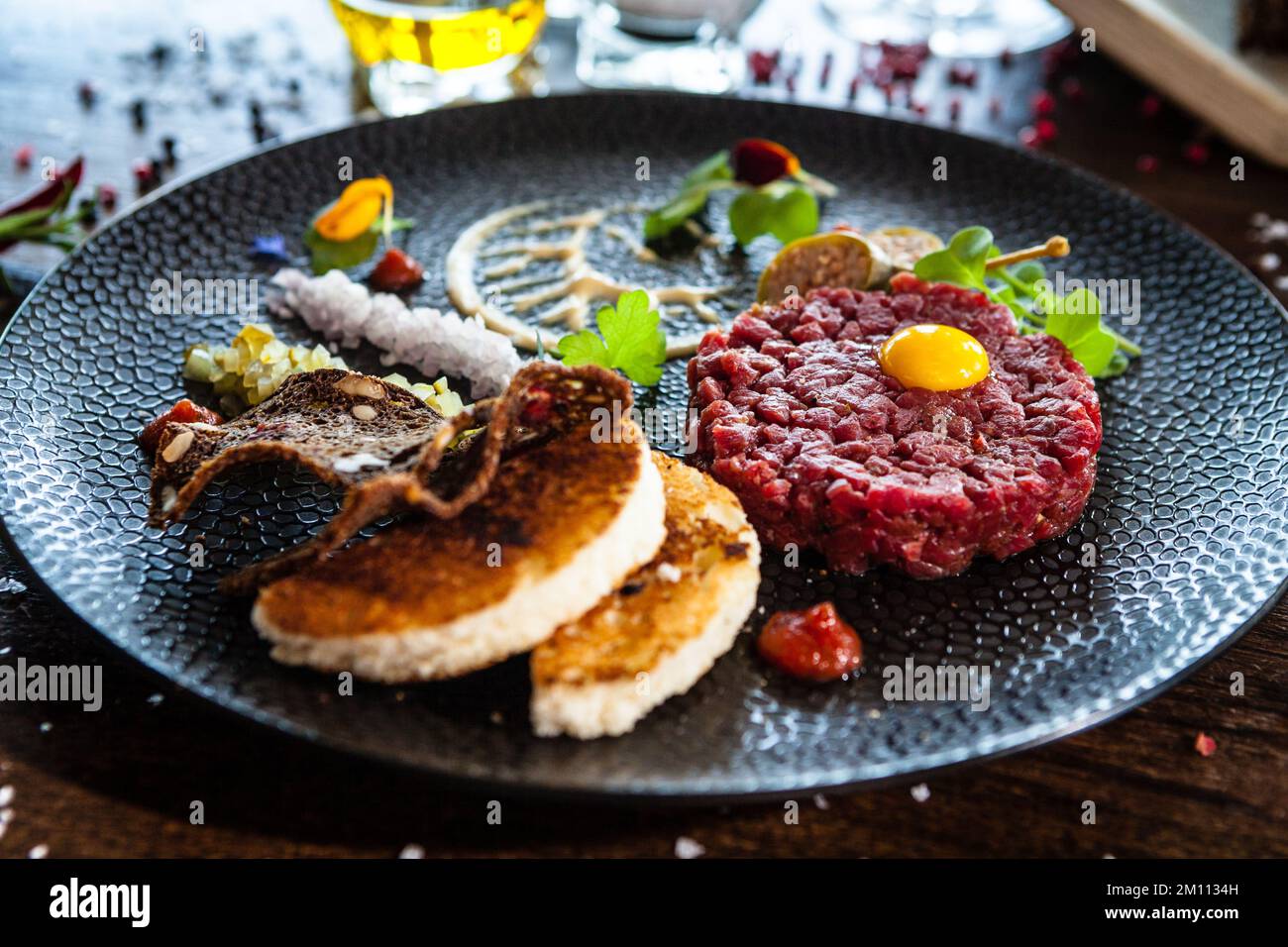 Beef tartare from Black Angus. Onion, quail egg, tomato sauce, mustard ...