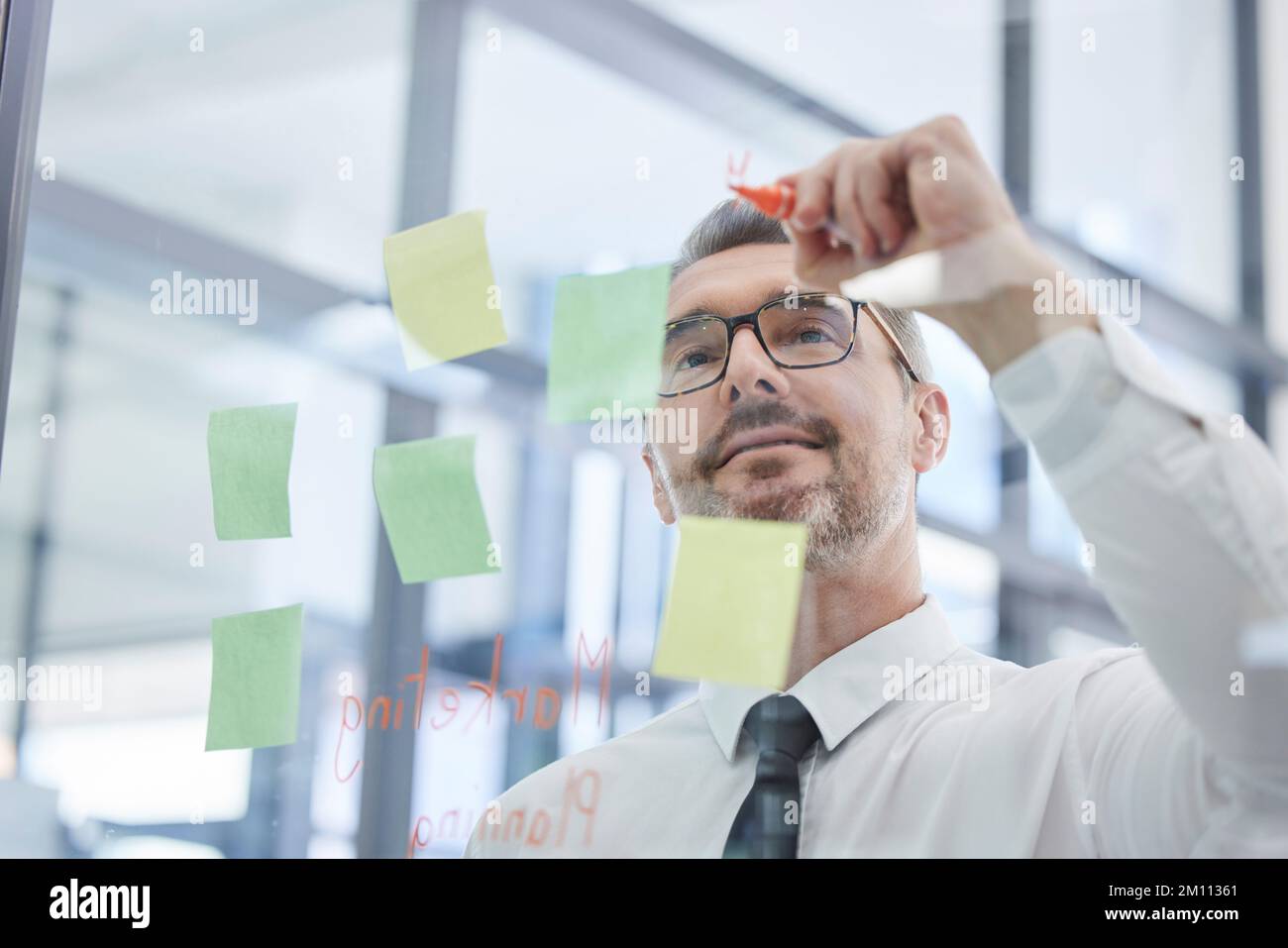 Vision, sticky notes and man writing idea in corporate office in ...