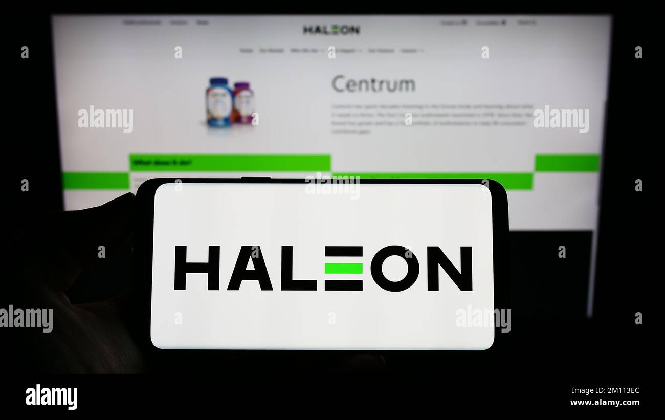 Person holding cellphone with logo of British consumer healthcare ...