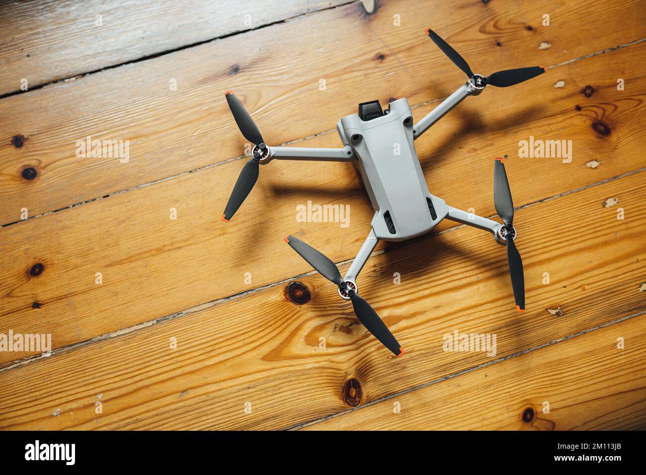 A top view of a small size drone placed on a wooden background Stock ...