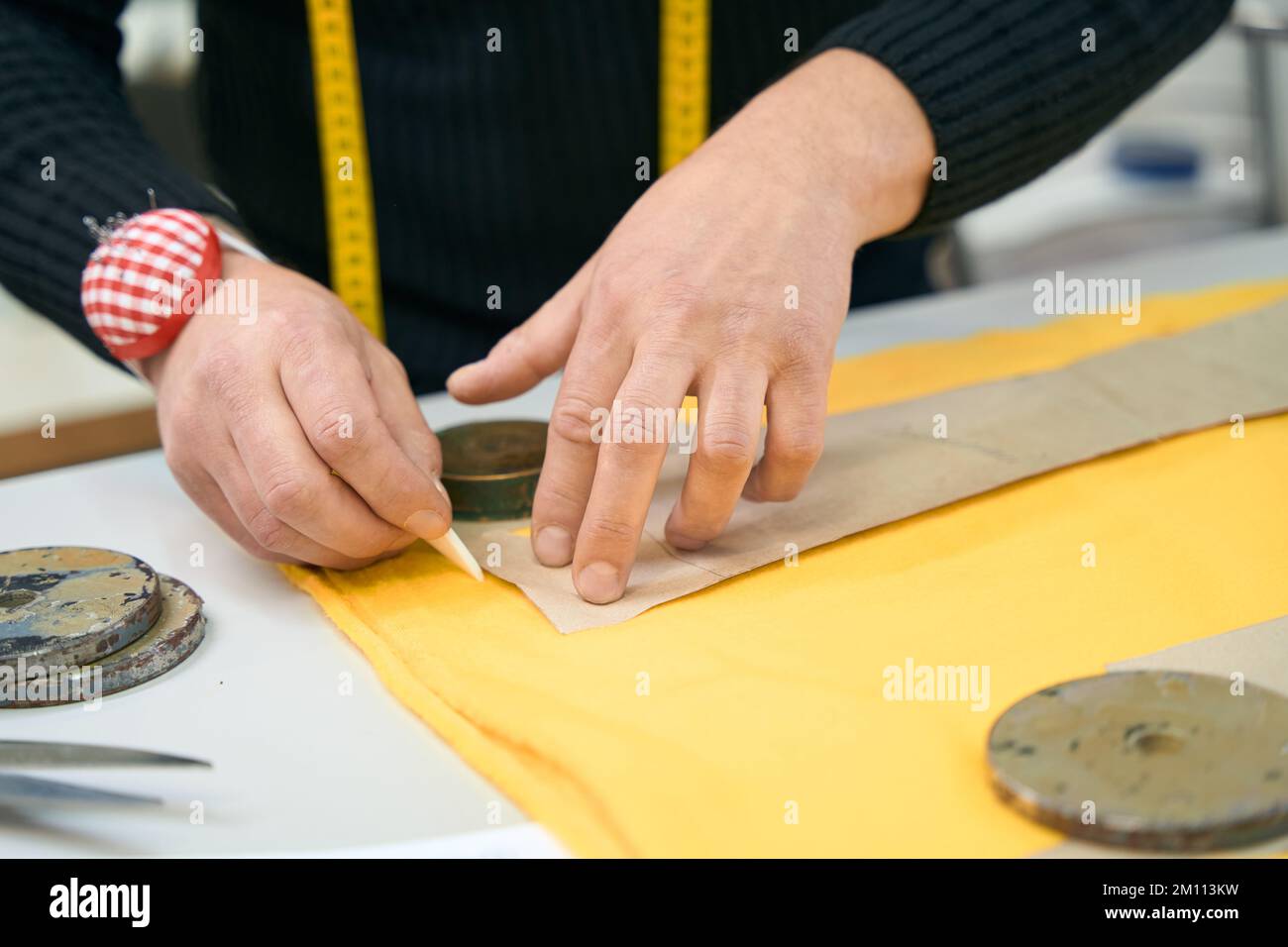 Tailor cutting fabrics hi-res stock photography and images - Alamy