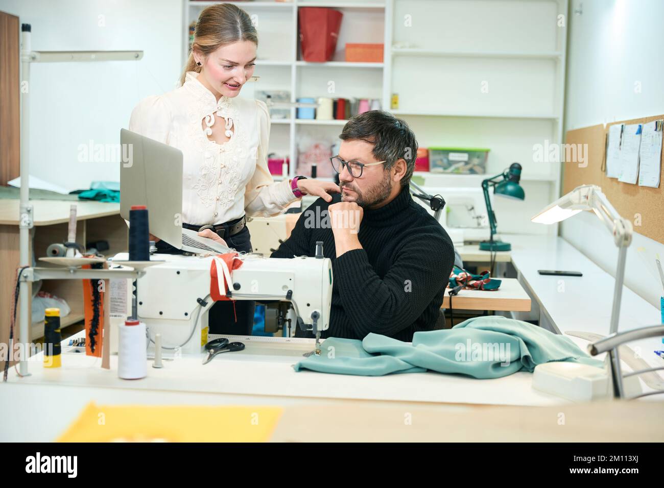 Woman manager oversees the execution of work in sewing studio Stock ...