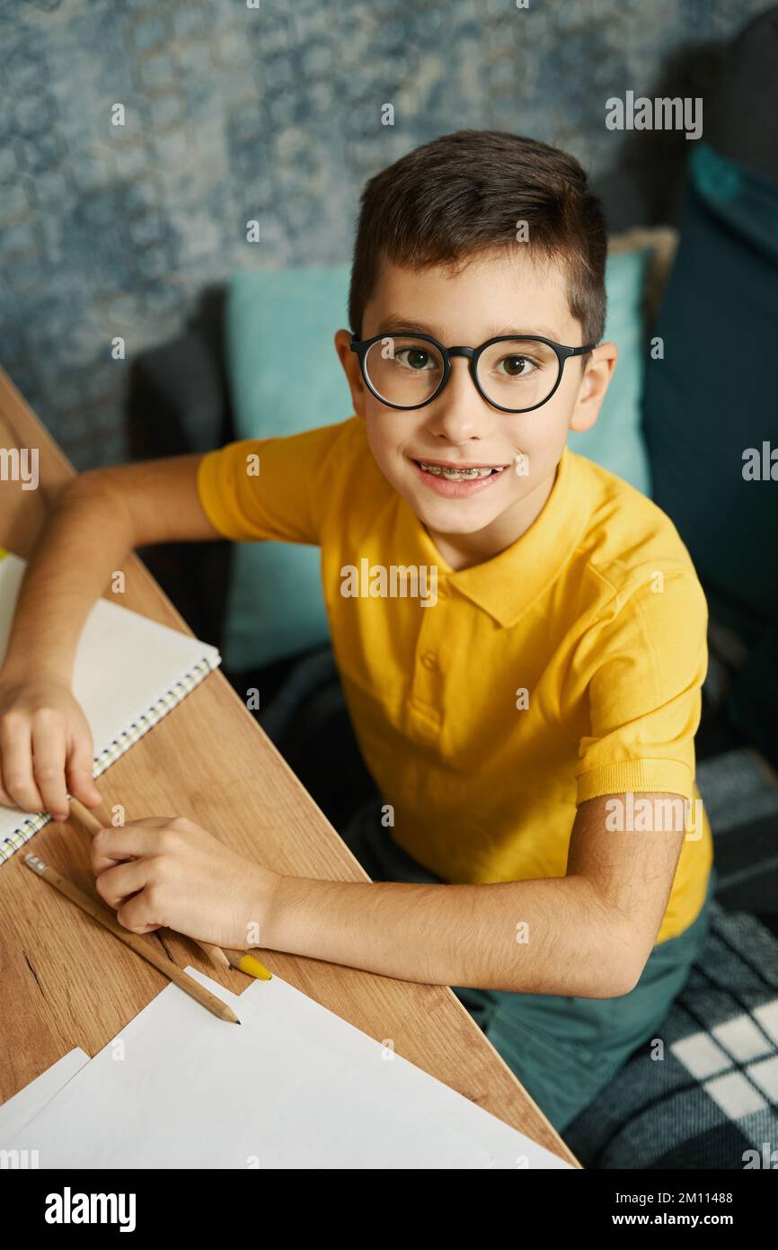 Smiling boy studying at home during quarantine Stock Photo - Alamy