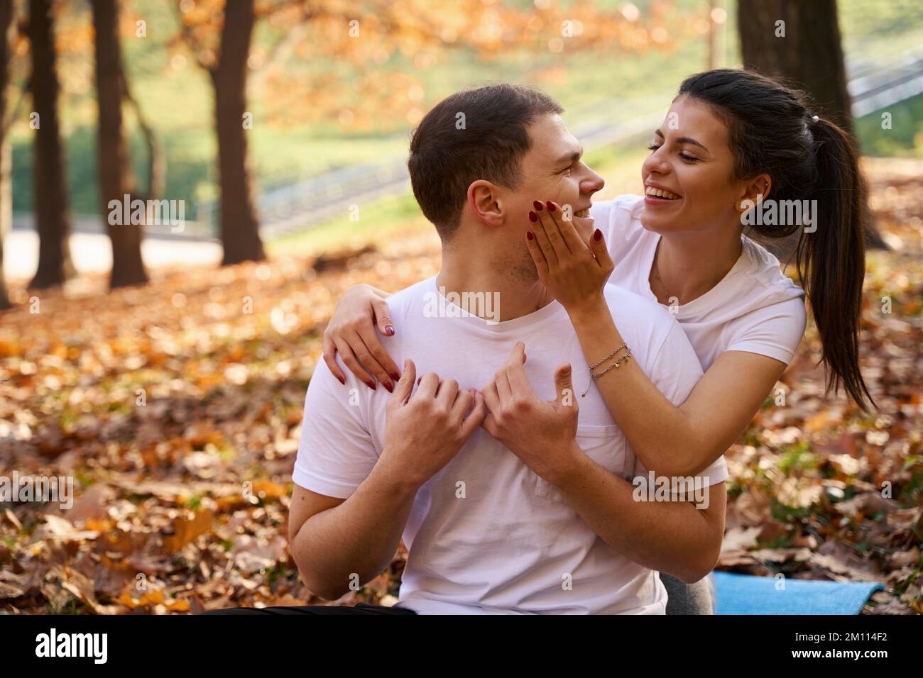 Charming young woman is hugging her boyfriend Stock Photo - Alamy