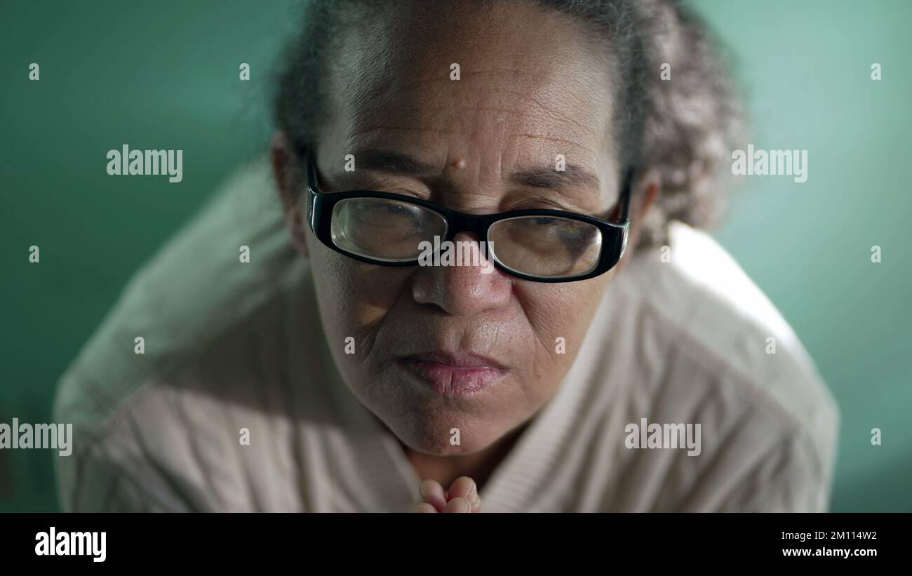 Religious older senior hispanic woman praying to God. Spiritual South ...