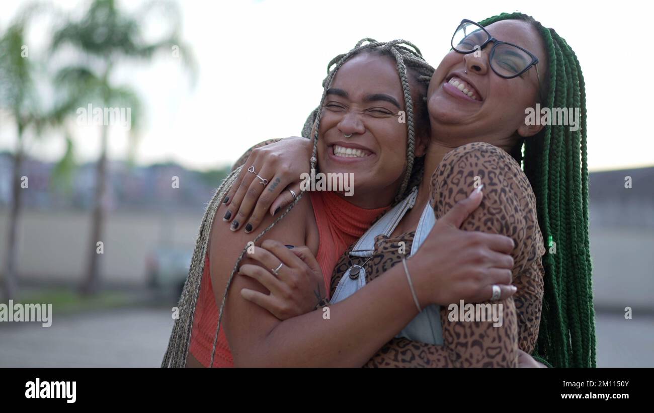 Two happy black sisters holding pregnant sister belly expecting baby ...