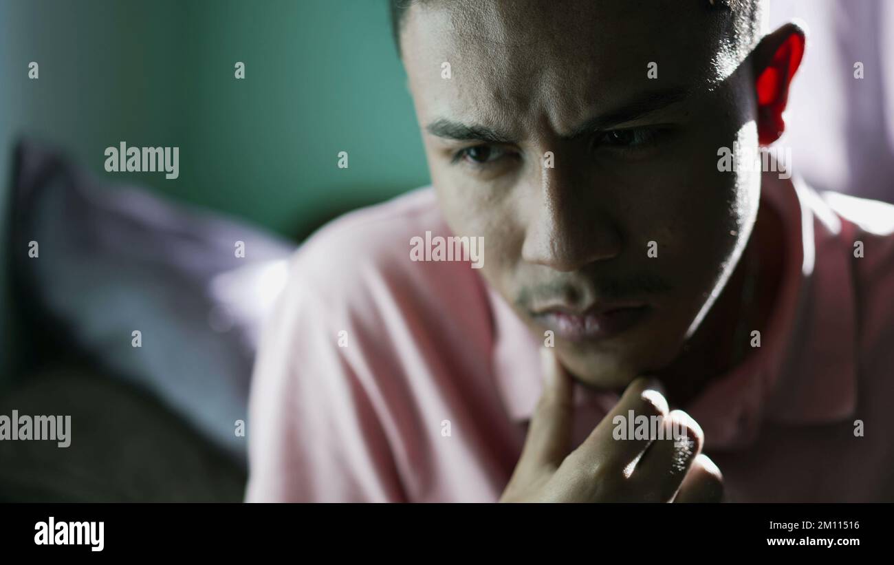 Thoughtful person thinking deeply about solution. Pensive South ...