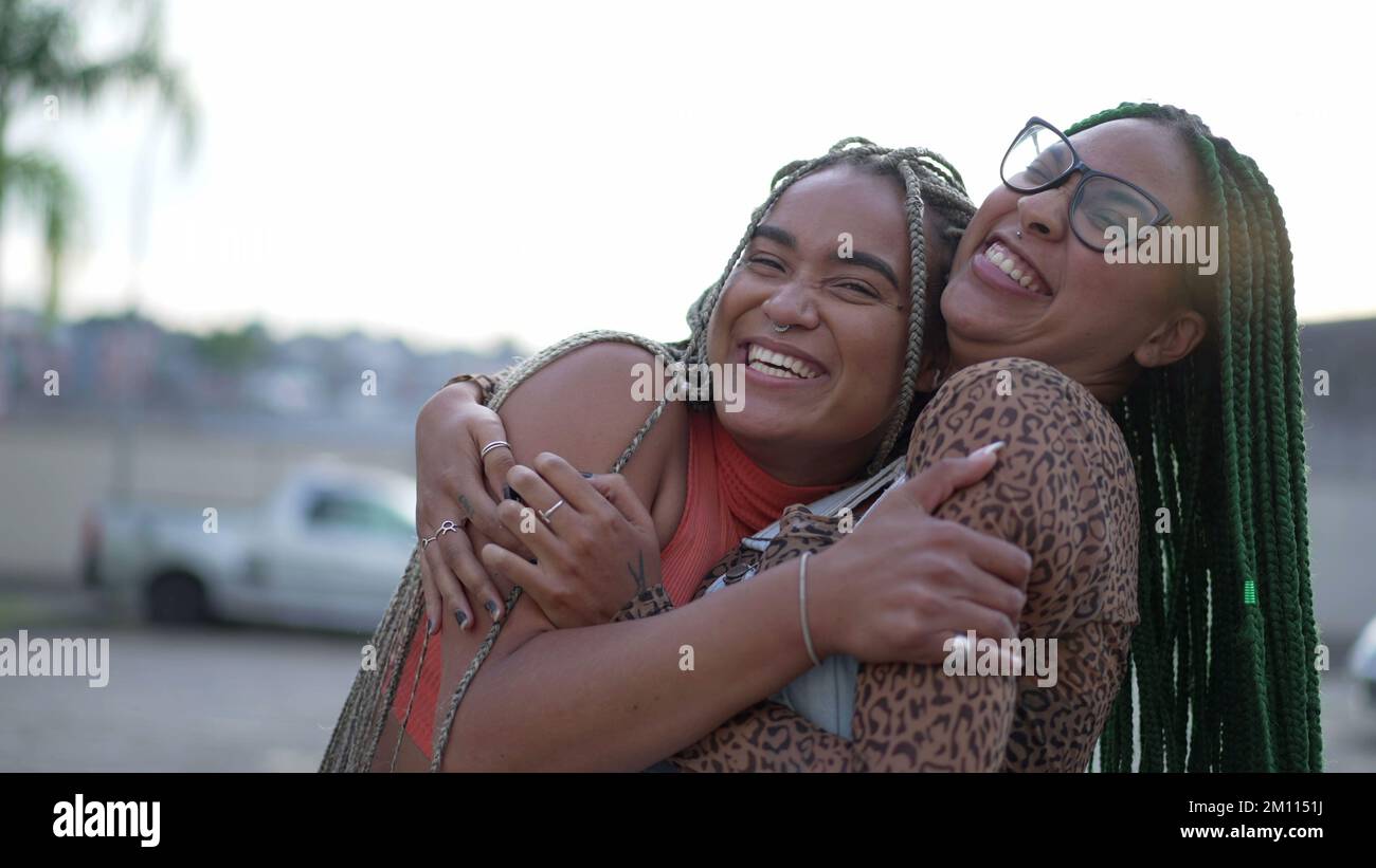 Two happy black sisters holding pregnant sister belly expecting baby ...