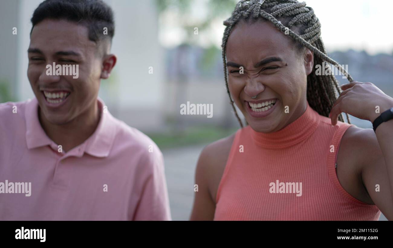 Two hispanic black people laughing and smiling. Brazilian friends ...
