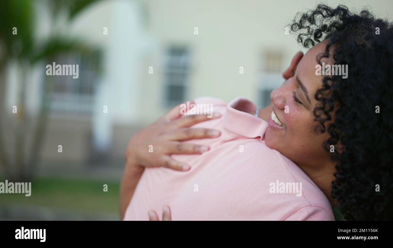 Young woman embracing male friend. Authentic real life reunion ...