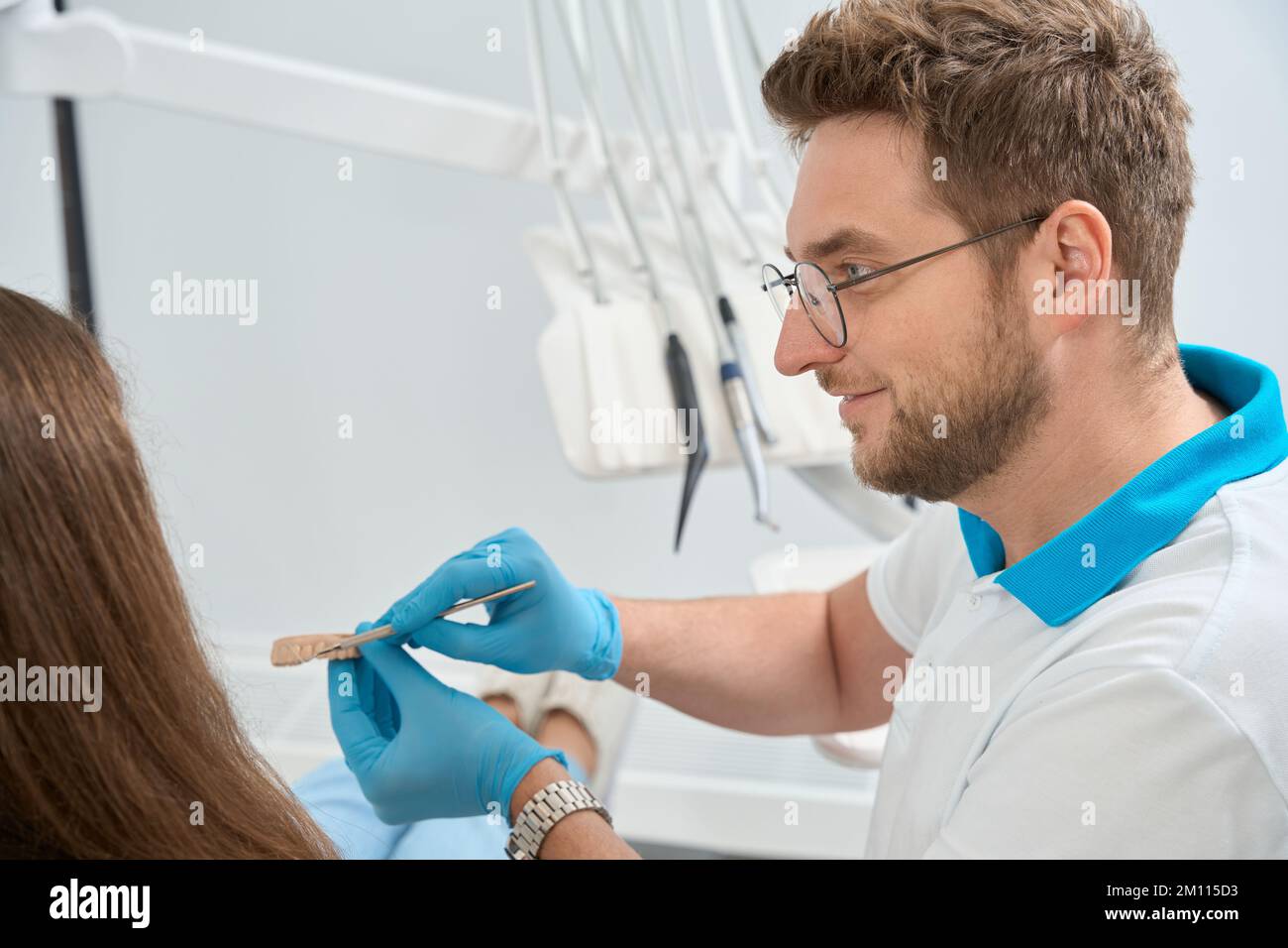Friendly doctor telling about oral hygiene basics to client Stock Photo ...