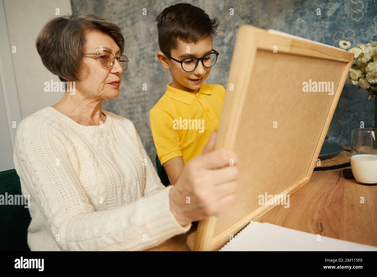 Teacher helping boy study math at home Stock Photo - Alamy