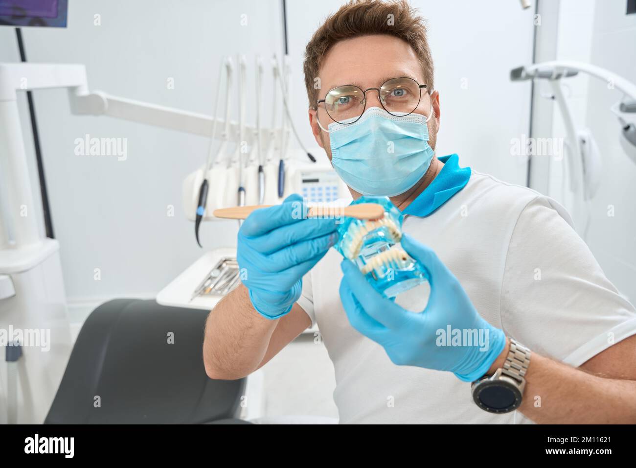 Stomatologist showing proper tooth-brushing technique before camera ...