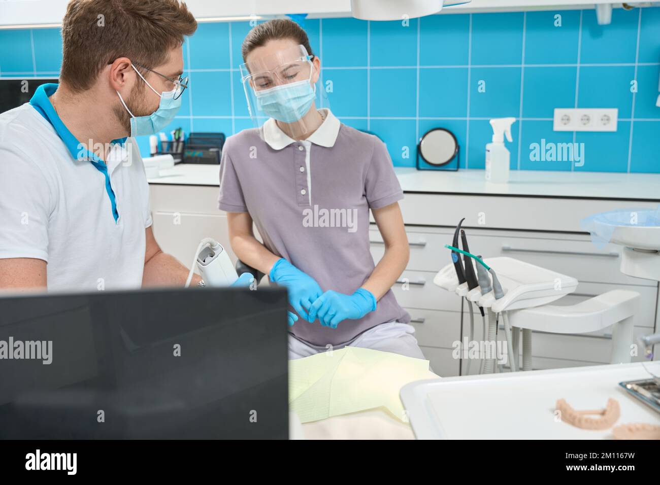 Stomatologist and nurse during examination of client teeth Stock Photo ...