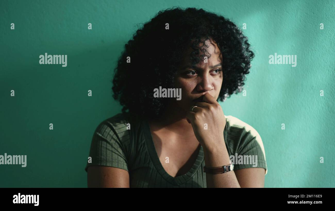 A concerned African American young woman. A pensive hispanic latin girl ...