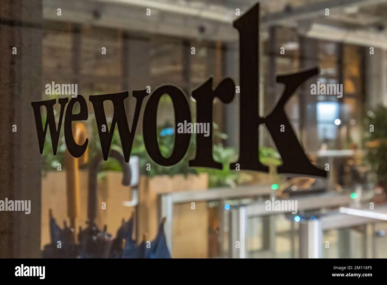 The Wework sign on the window of the building at night, Frankfurt am ...