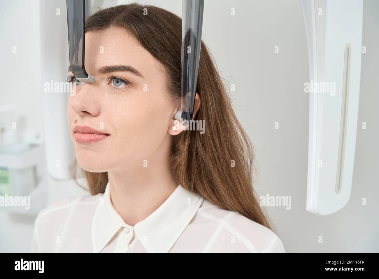 Dental clinic client during diagnostic procedure on ultramodern ...