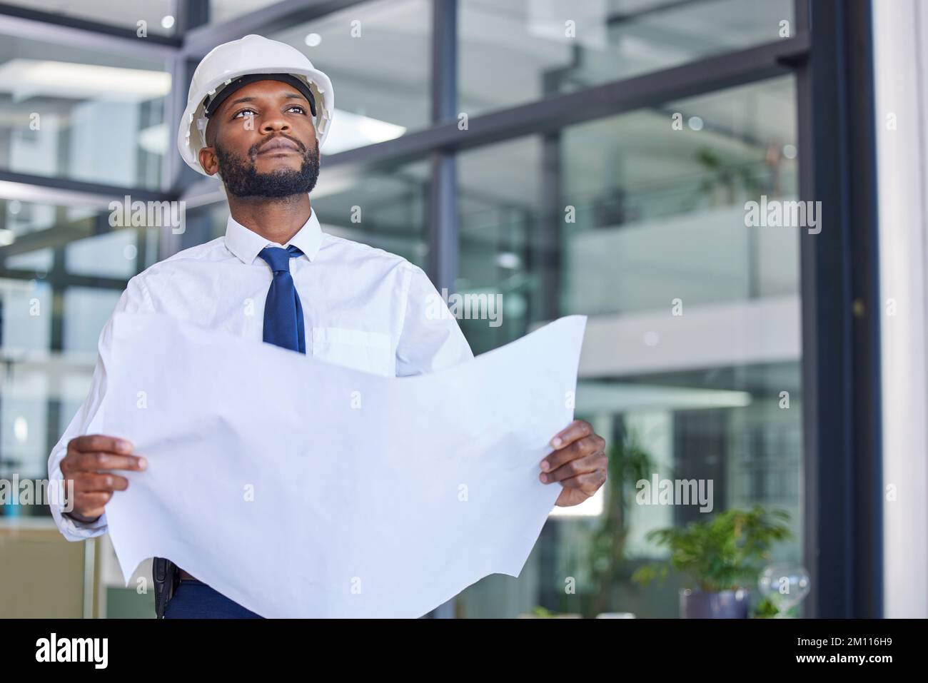Black man, architect and blueprint in construction planning, thinking ...