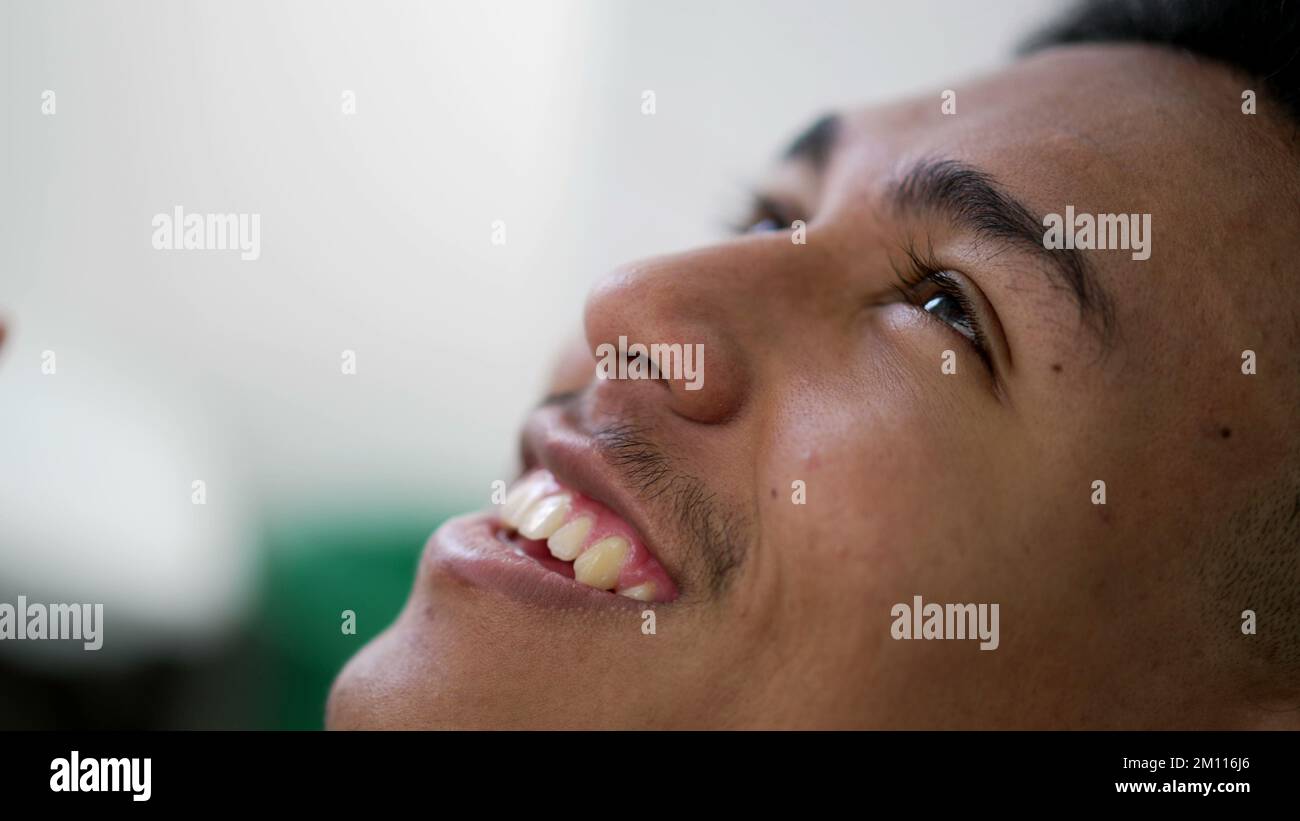 Brazilian man closeup face looking at sky smiling. happy faithful ...