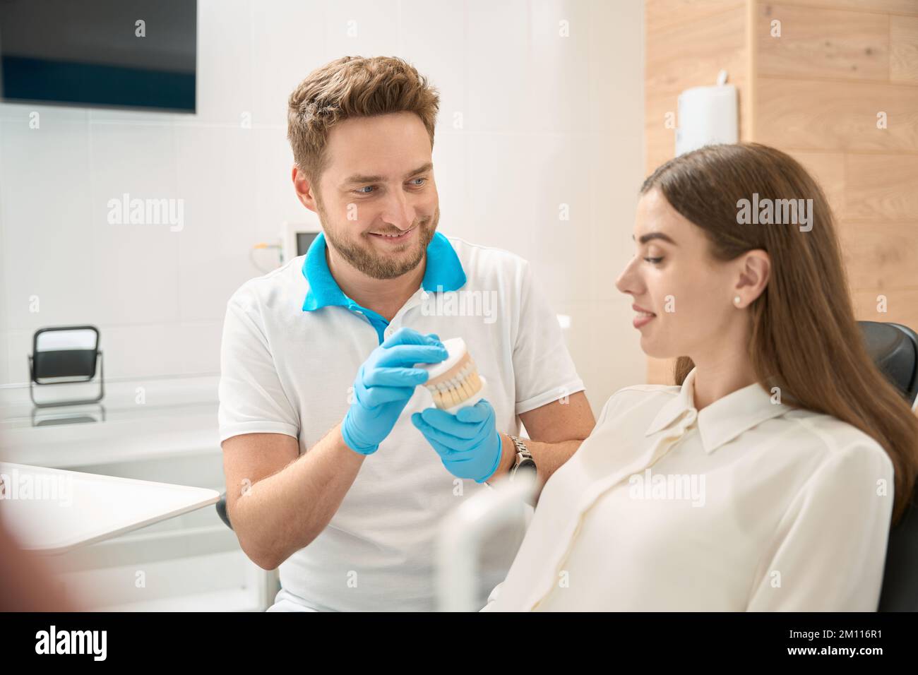 Experienced orthodontist preparing client for treatment procedure Stock ...