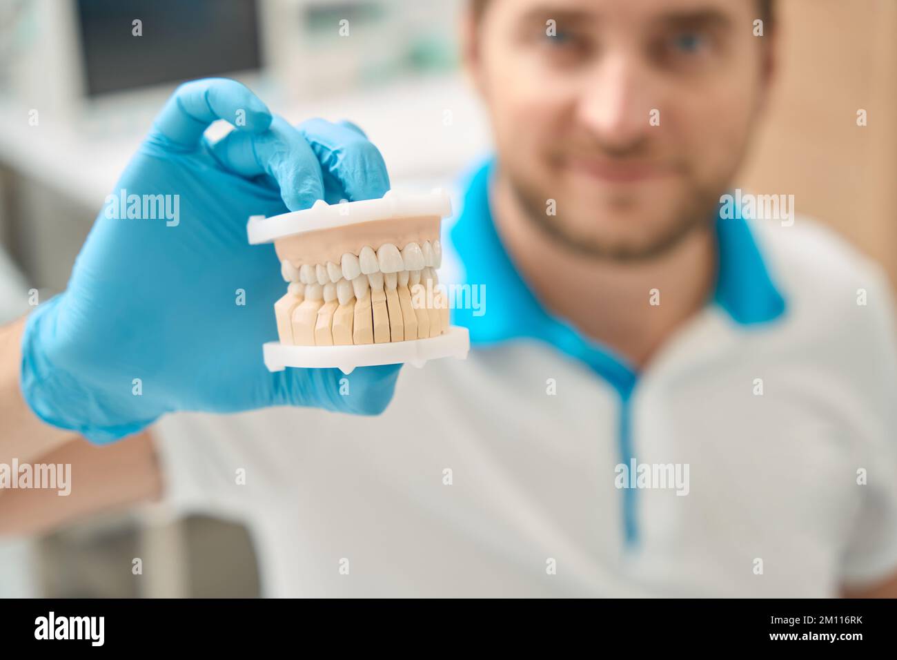 Professional dentist showing model of the oral cavity Stock Photo - Alamy
