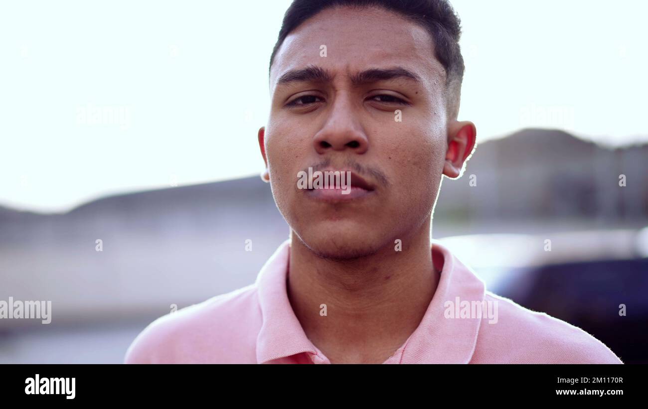 One serious hispanic man looking at camera with skeptical emotion ...