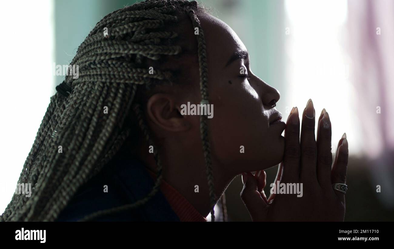 One Spiritual young black woman praying to God having HOPE and FAITH ...