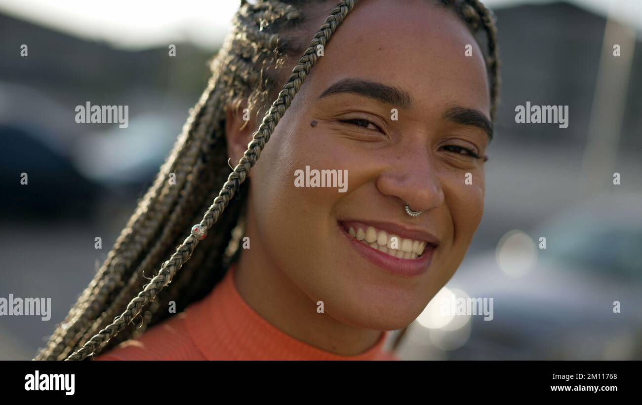 Portrait of a black hispanic latin young woman smiling at camera. Brazilian latin adult girl ...
