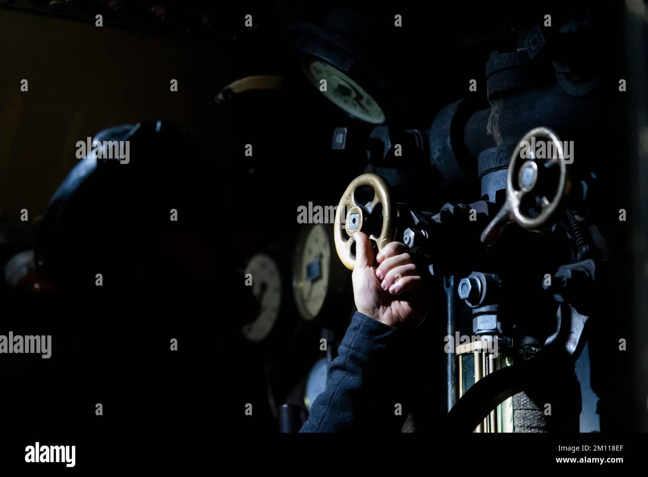 Driver operating regulator in cab of Stanier Class 5 steam locomotive ...