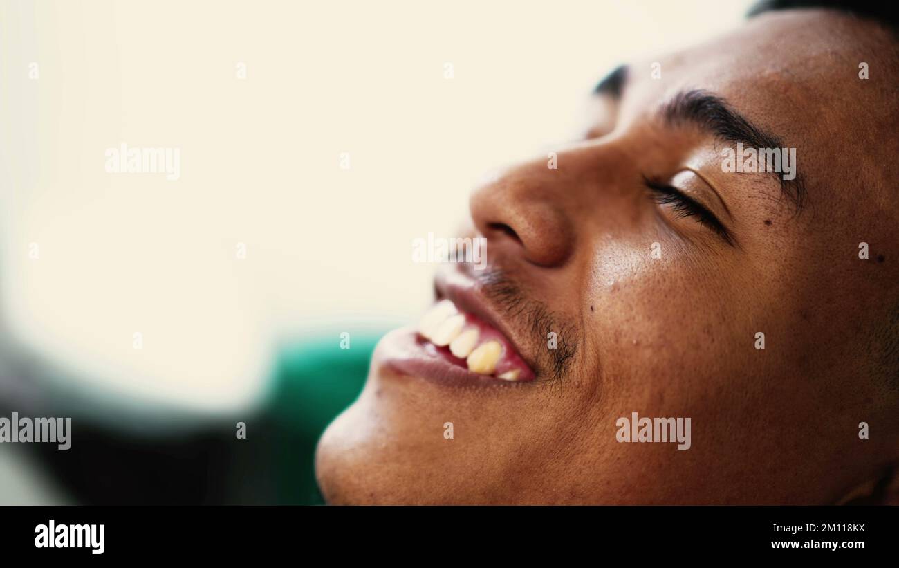 Happy hispanic man closing eyes in contemplation and meditation. South ...
