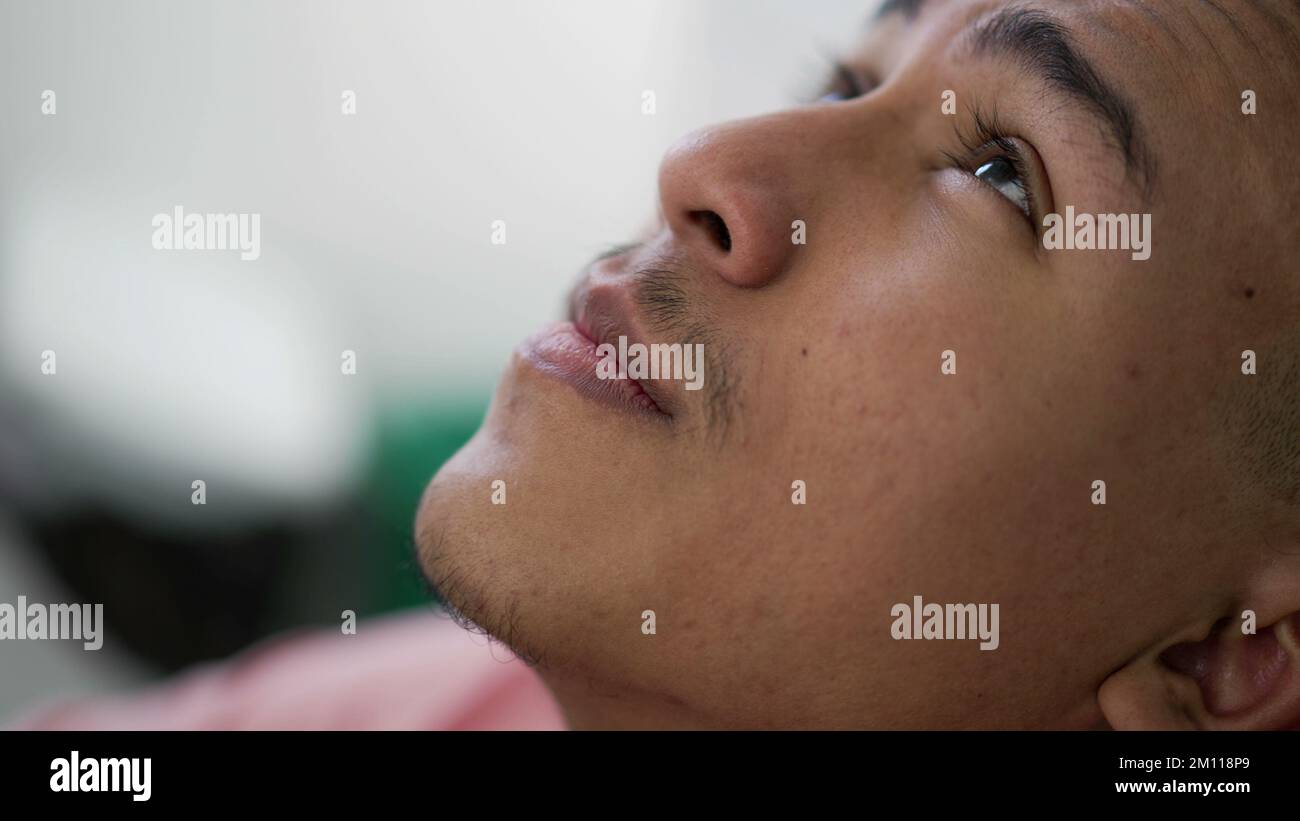 Hispanic young man closeup face looking at sky in contemplation. South ...