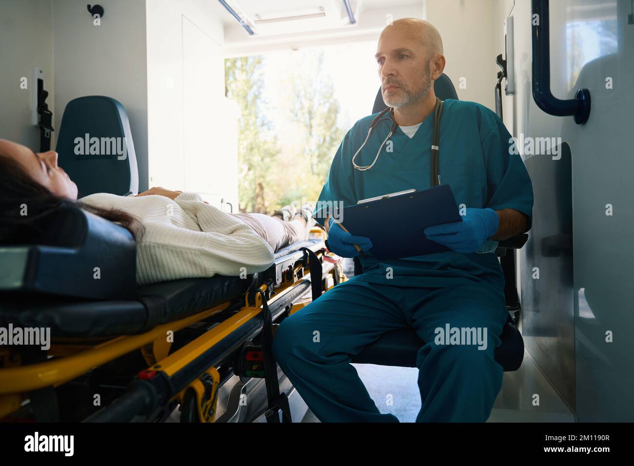 Doctor in medical uniform draws up hospitalization of the patient Stock ...