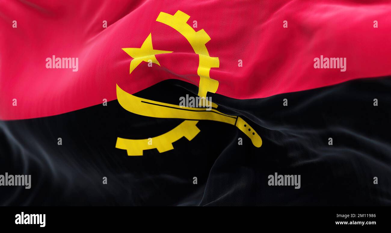 Close-up view of the Angola national flag waving in the wind. The ...