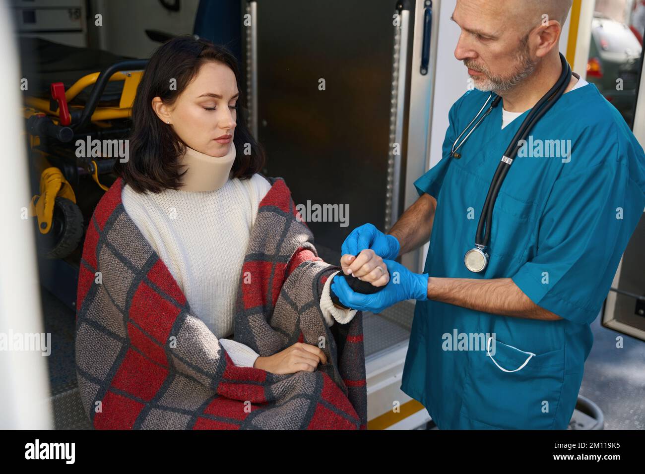 Ambulance crew member is giving first aid to a woman Stock Photo - Alamy