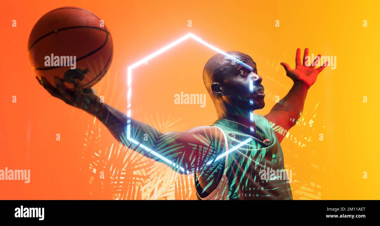 Shocked bald african american player with arms outstretched by glowing ...
