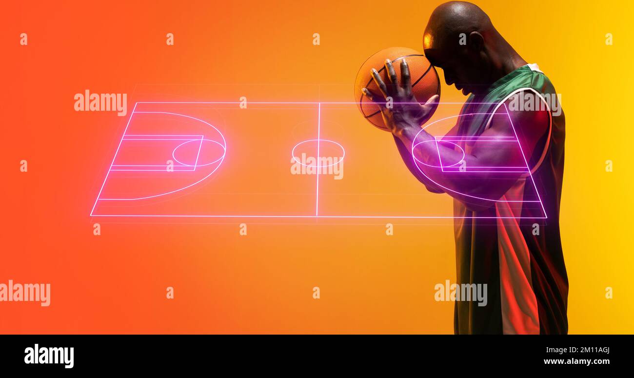 Side view of stressed bald african american player holding ball on ...