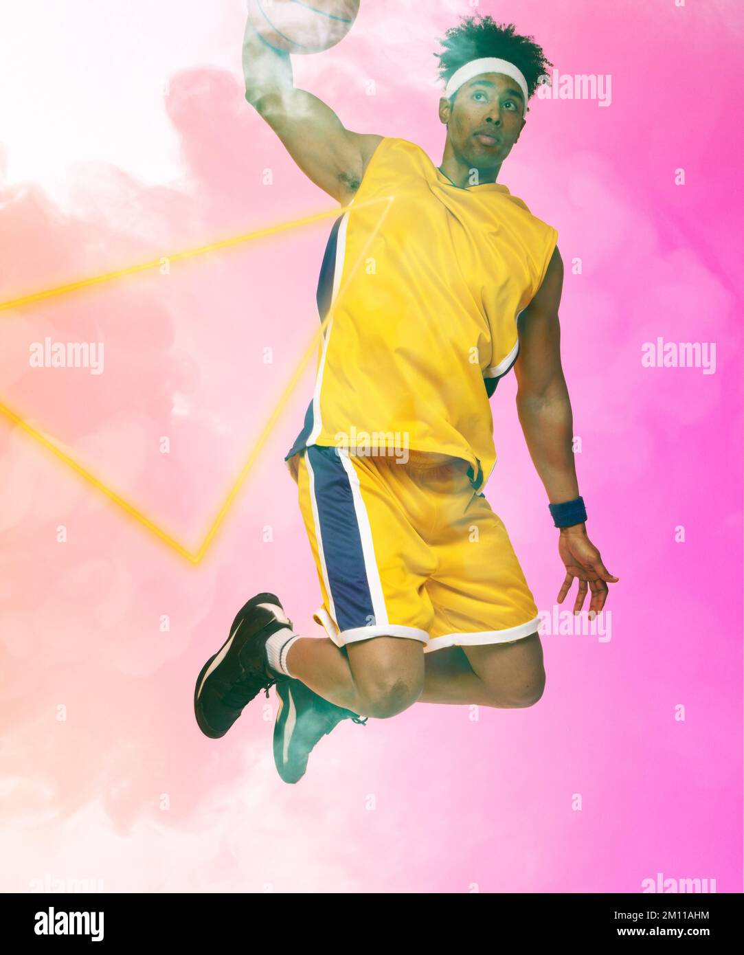 Composite of biracial basketball player taking shot with ball by ...