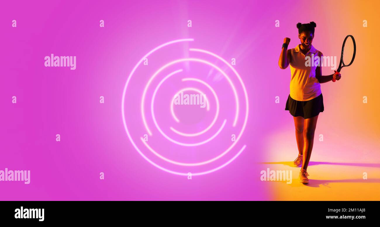 Full length of cheerful biracial female tennis player with racket ...