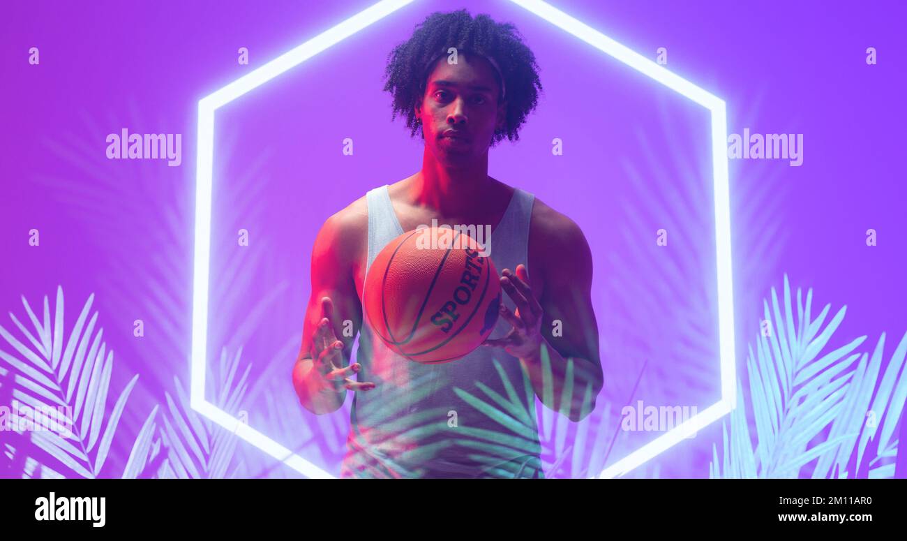 Illuminated hexagon and plants over biracial basketball player with ...
